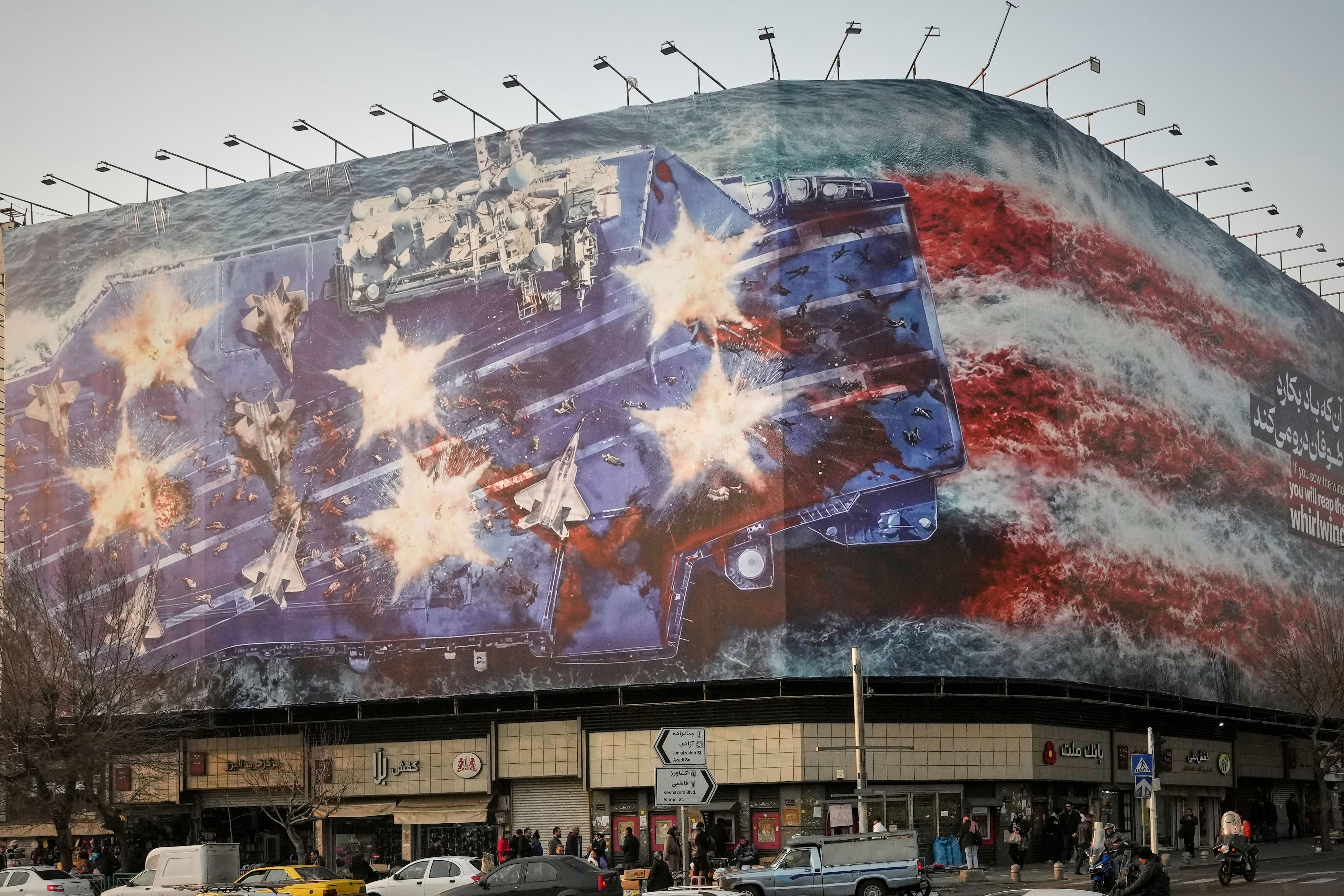 Iran unveils blood-stained flag mural as US military arrives