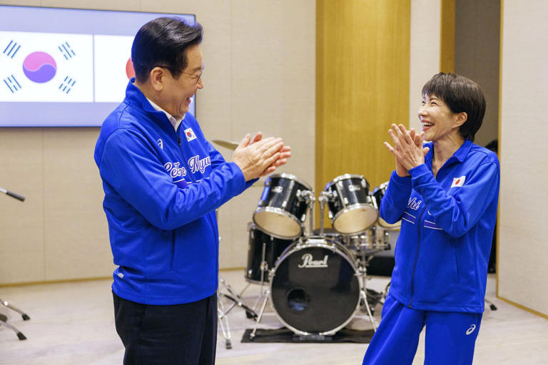 Japanese and South Korean leaders jam to K-pop hits at a summit