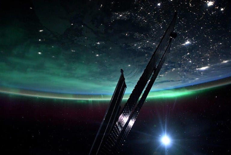 NASA astronauts film stunning footage of a glowing green aurora from space