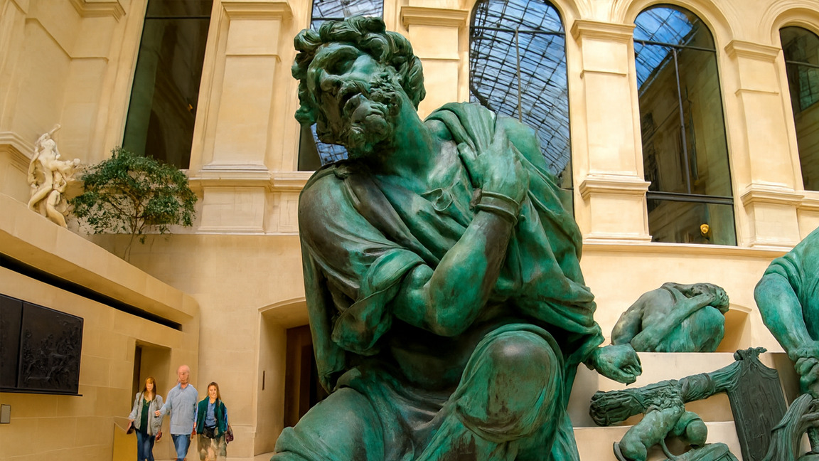 Louvre Museum interior with historic sculptures