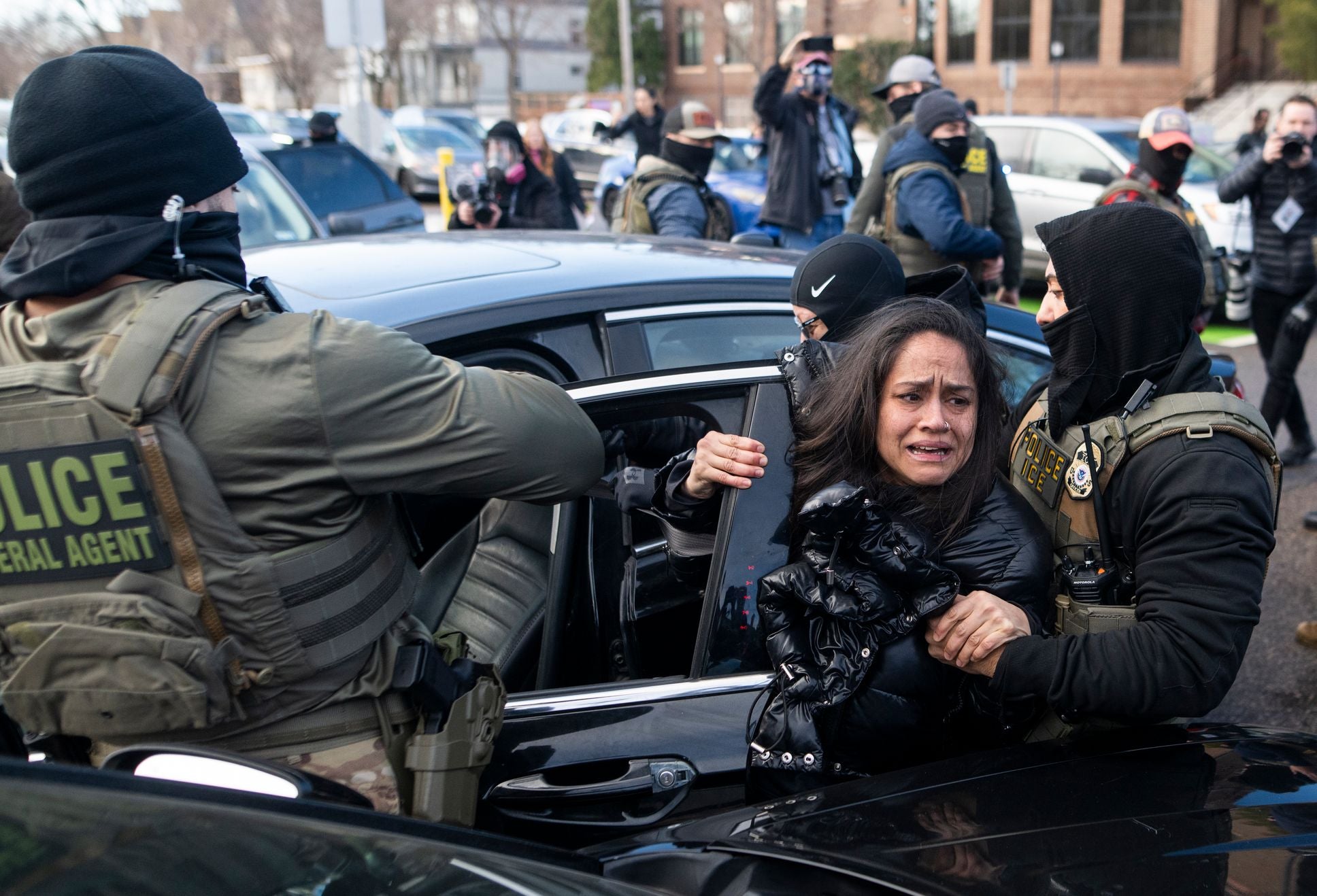 Woman dragged from car by ICE yells 'I'm disabled' in chaotic scene
