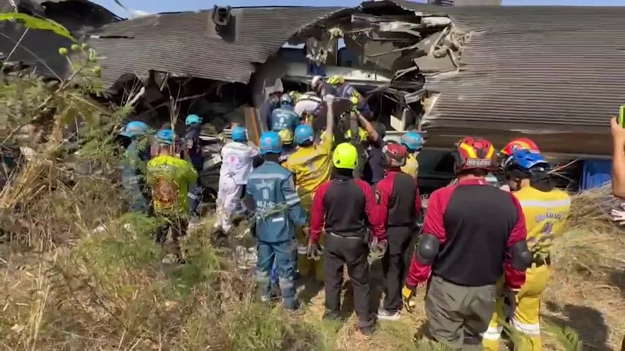 Firemen battle to reach bodies trapped inside Thailand train wreckage