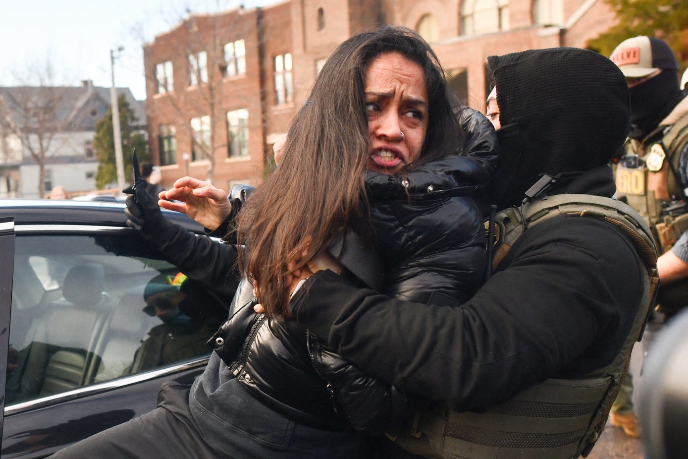 Woman dragged from car by ICE yells 'I'm disabled' in chaotic scene