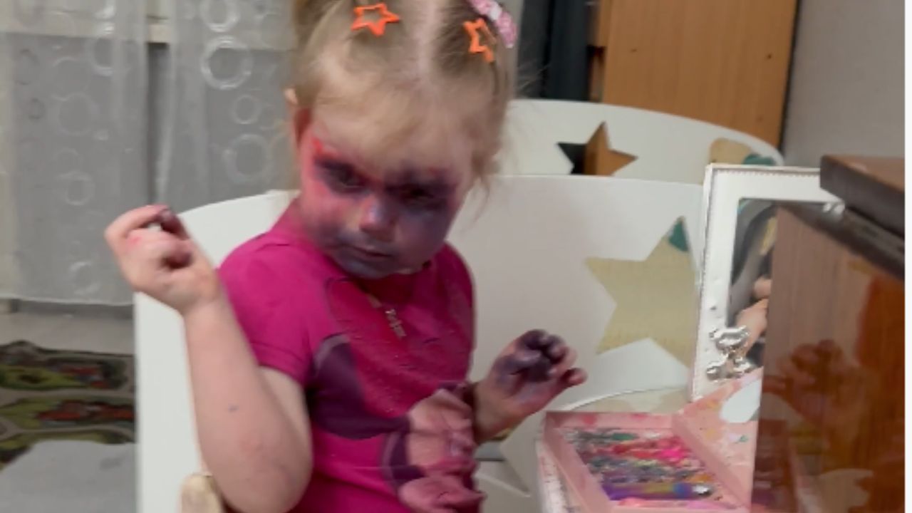 Little girl covers her face with makeup after being left alone briefly