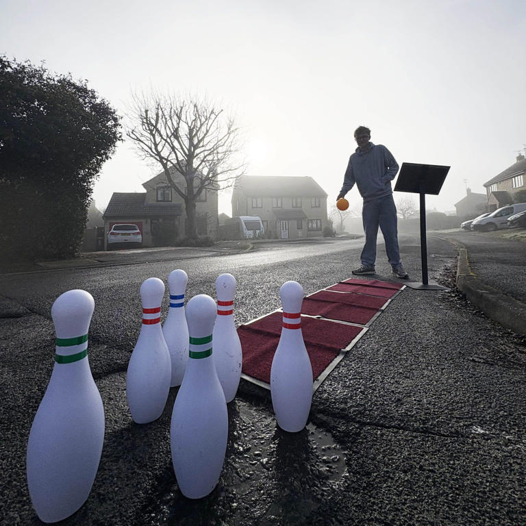 Man protests to fix Britain’s roads – by filling pothole with bowling pins