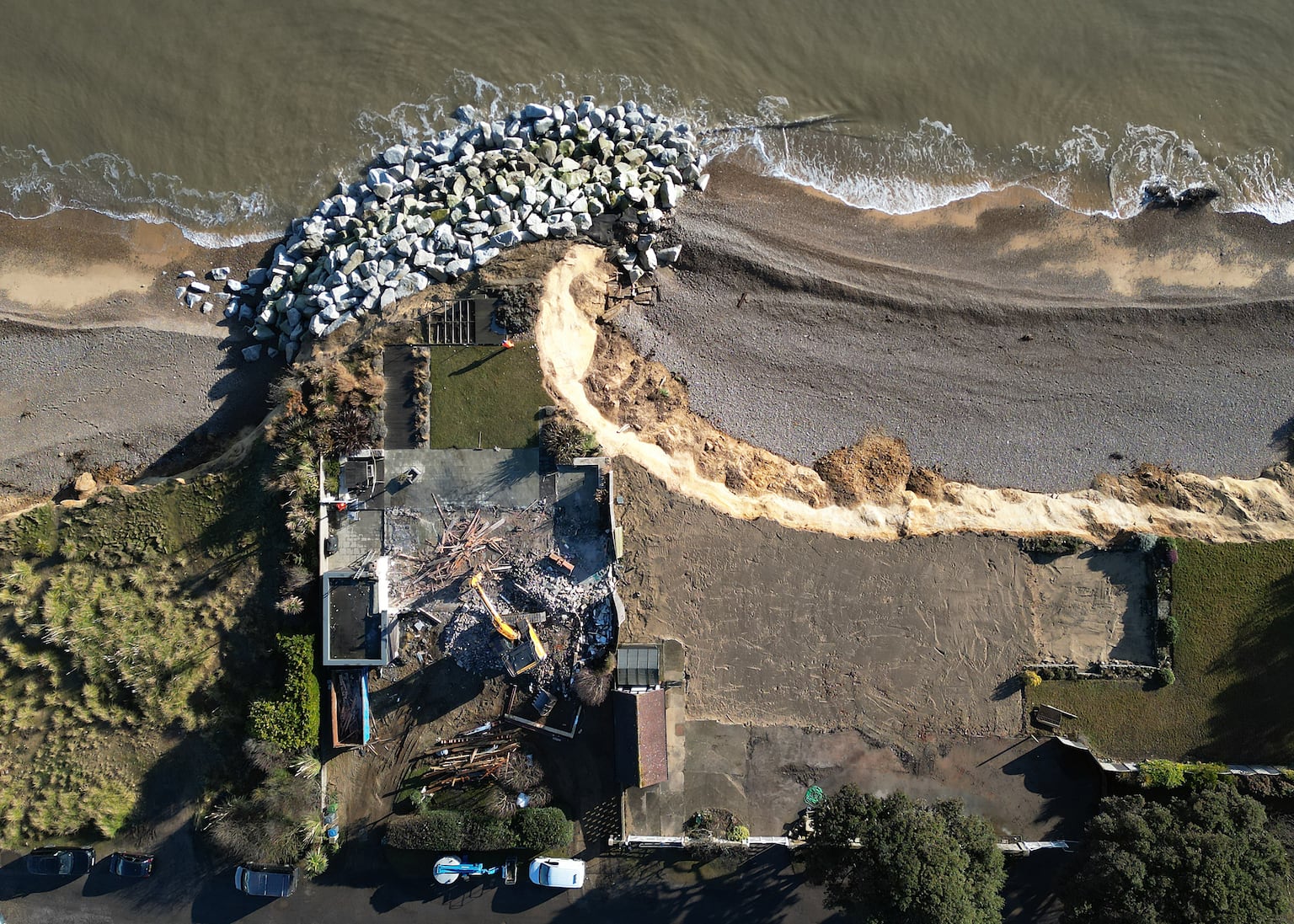 Aerial images show demolition of fourth clifftop home amid coastal erosion