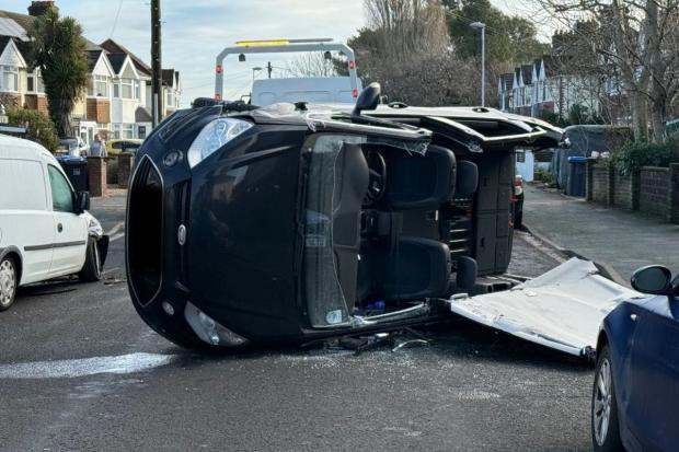Car overturns after crashing into parked van