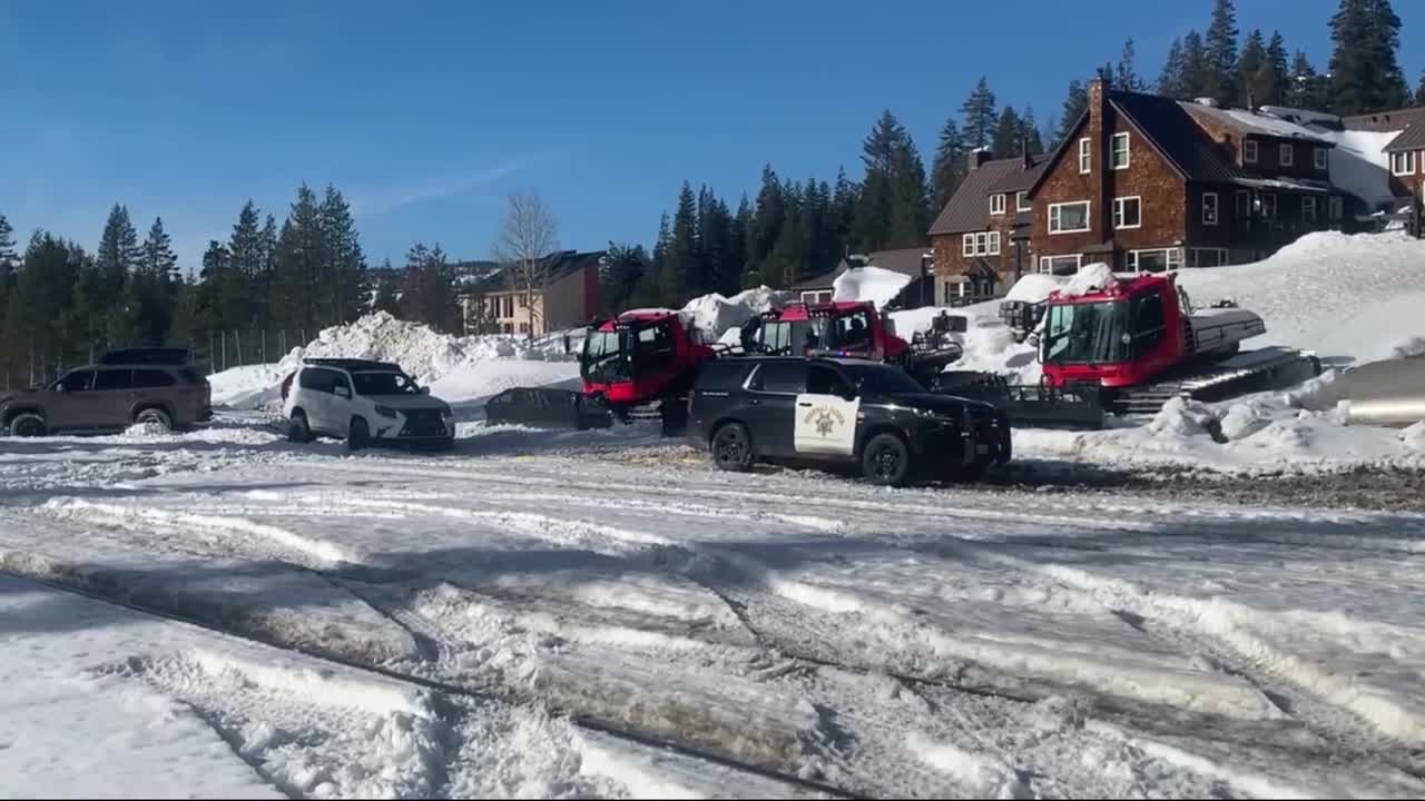 Police patrol car pulls stranded SUVs from snow in California