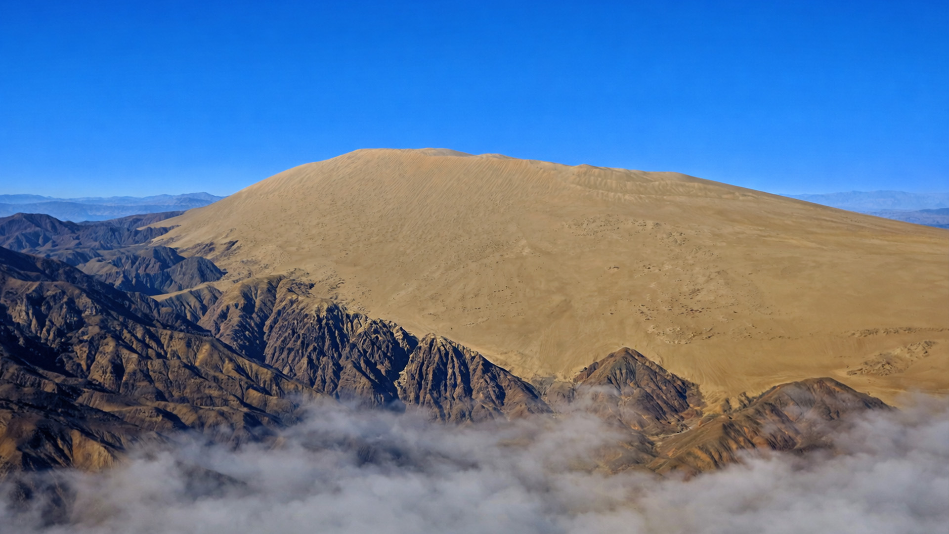 What creates the contrast between sand and rock here?