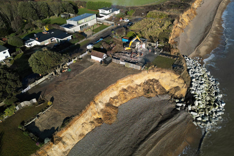 Aerial images show demolition of fourth clifftop home amid coastal erosion