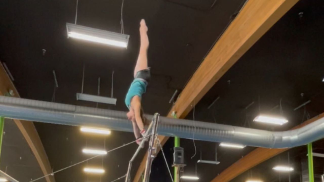 Gymnast trains on uneven bars before a fall turns the whole session around