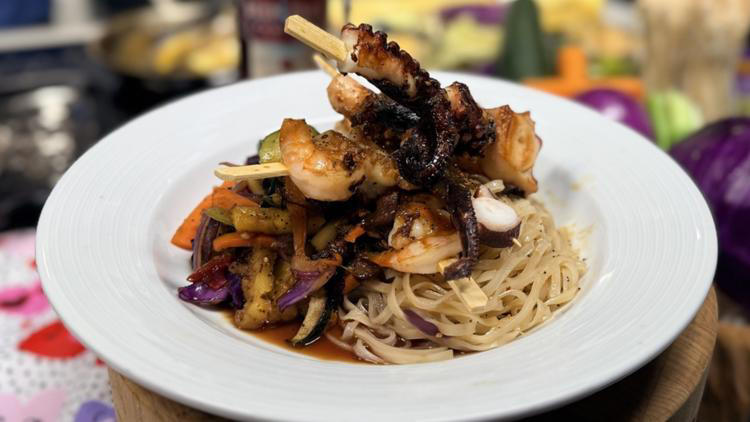Olivia's prepares octopus and shrimp kabobs with rice noodles