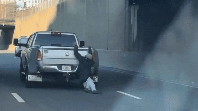 Disturbing moment person seen clinging to truck driving on ...