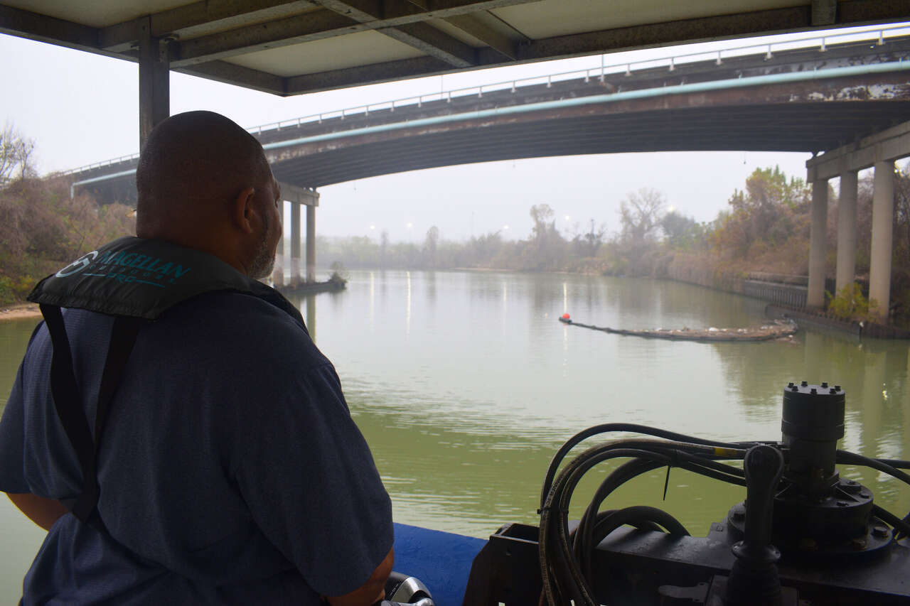 Who cleans trash out of Buffalo Bayou? Two guys and a hungry little boat.