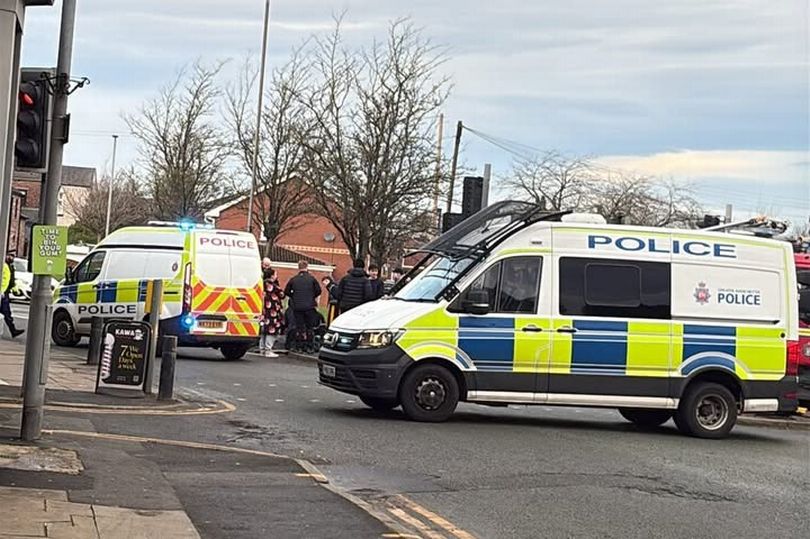 Police and paramedics close off road as elderly man rushed to hospital