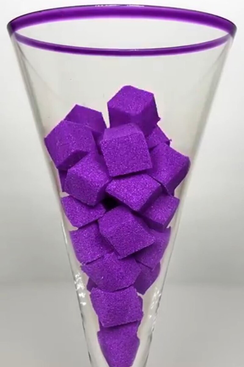 Purple sand cubes in glass