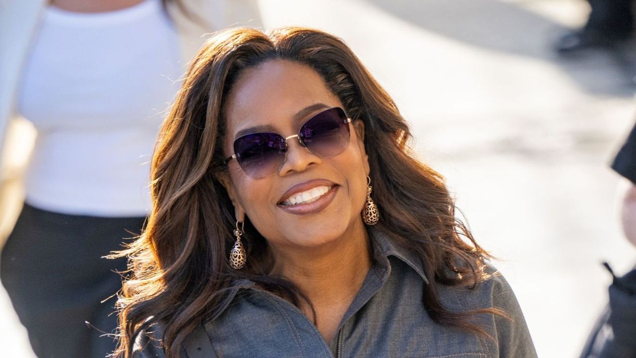 Oprah Winfrey wears ME+EM camel trousers and cerulean blue blouse
