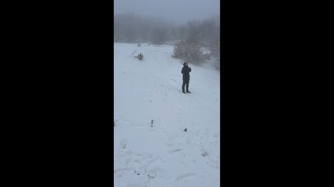 Man accidentally bumps friend while sliding on snow in Leinster, Ireland
