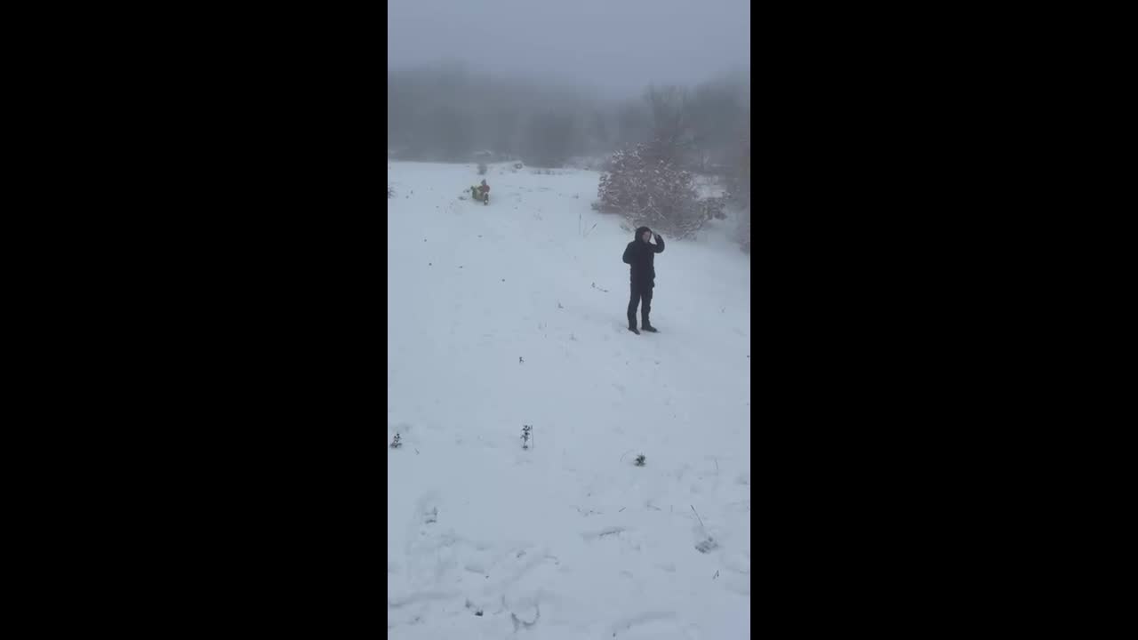 Man accidentally bumps friend while sliding on snow in Leinster, Ireland