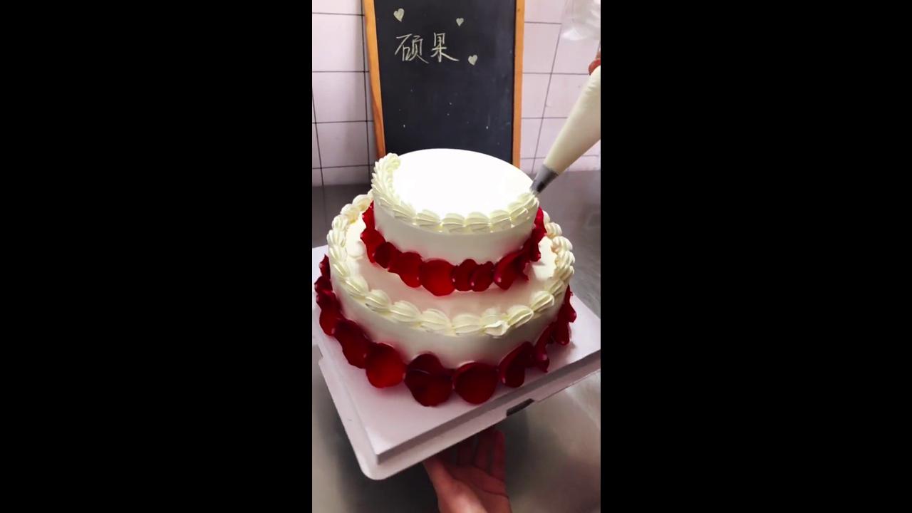 Making White With Fruits And Red Petals Cake