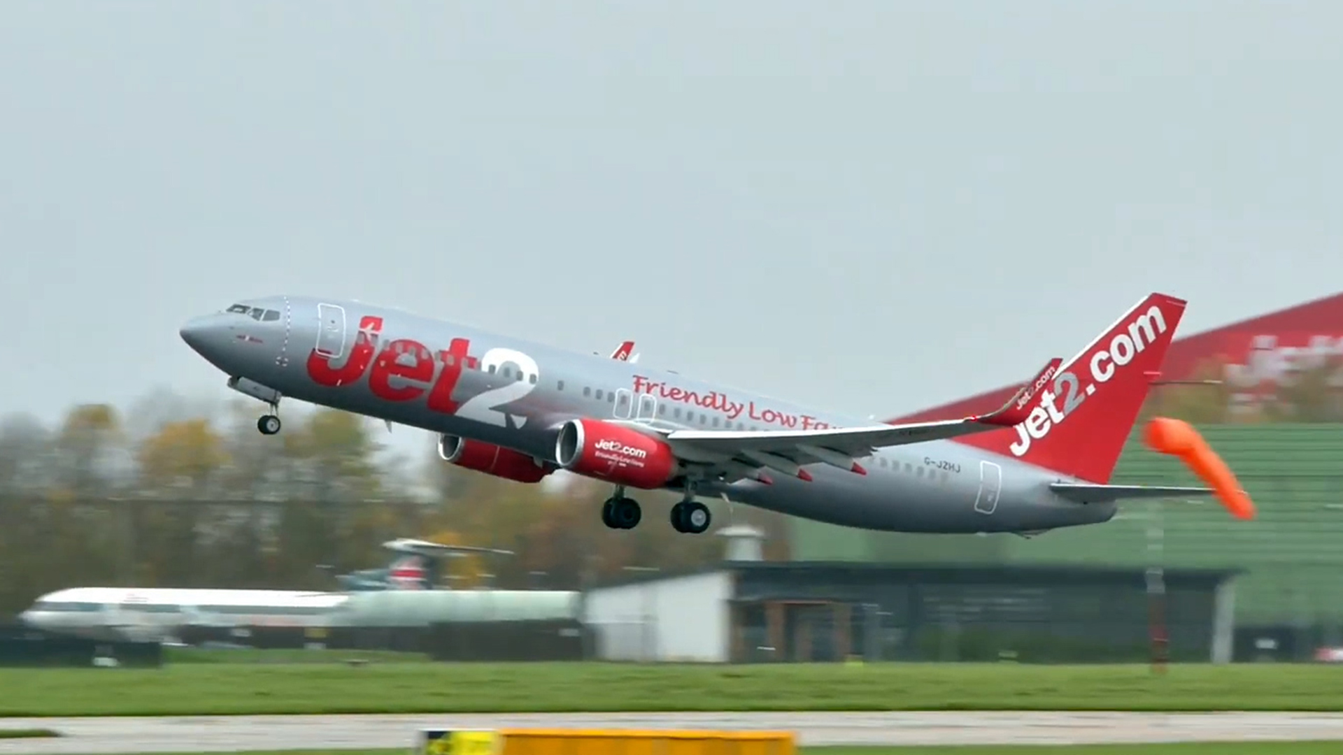 Taking off in heavy rain at a busy airport