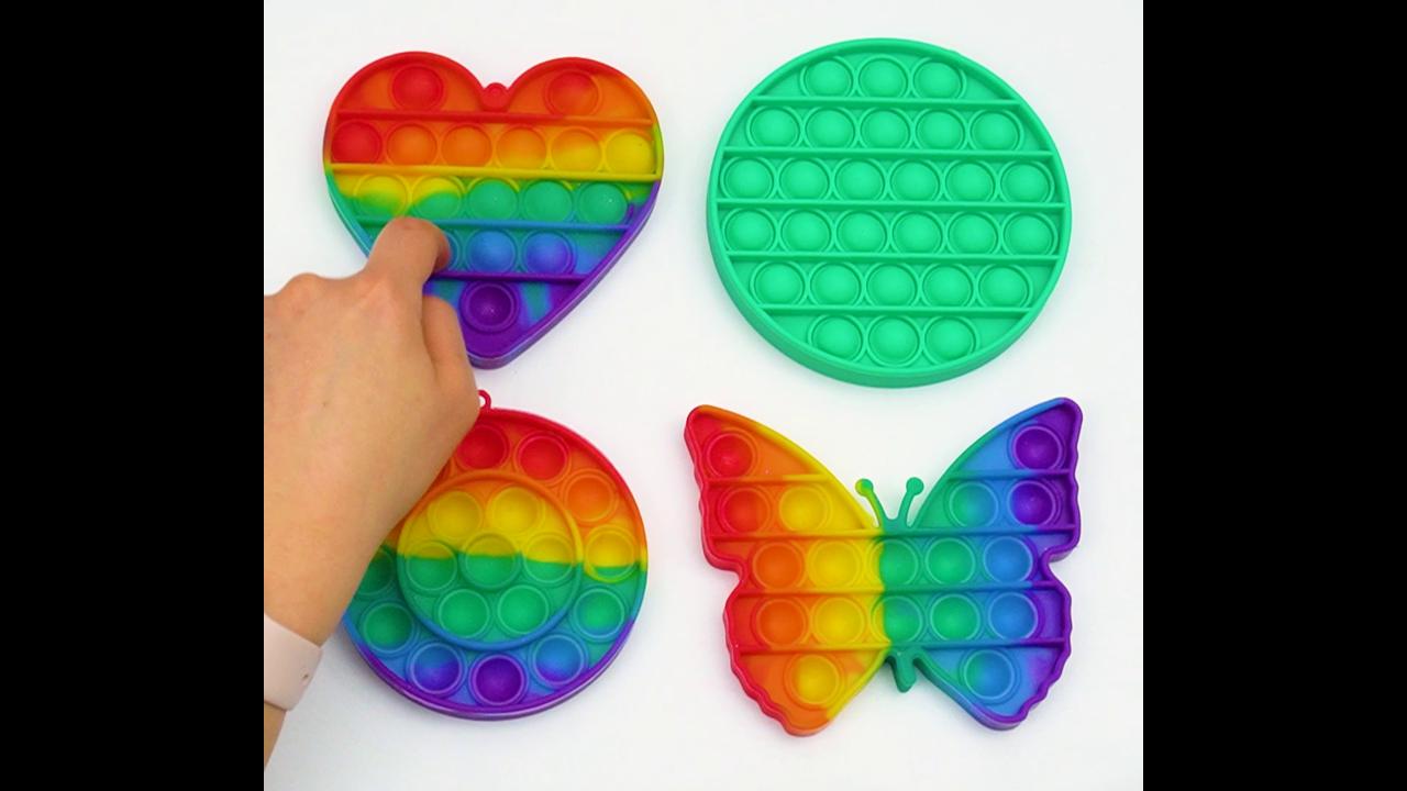 Playing with colorful pop it toys
