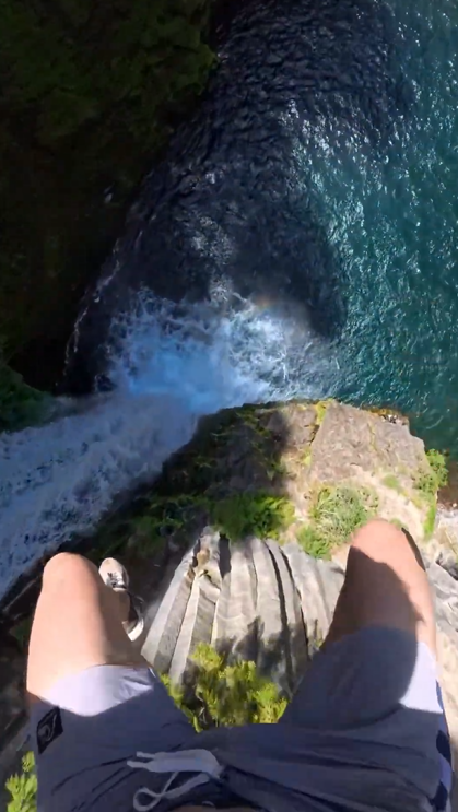 Daring 30m cliff jump between two trees