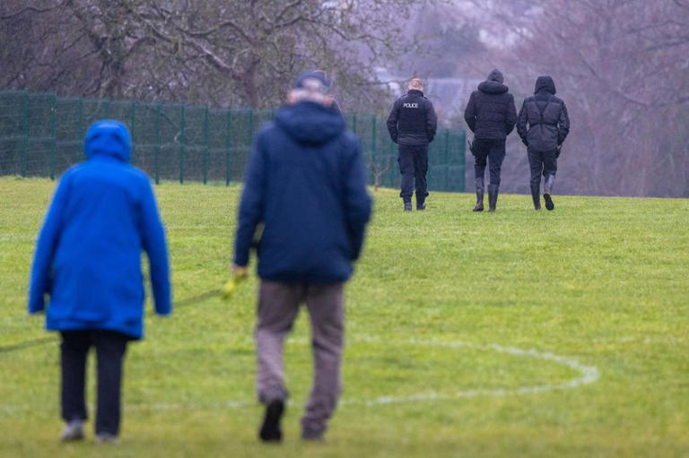 Police called to 'hostile' school playing field stand-off