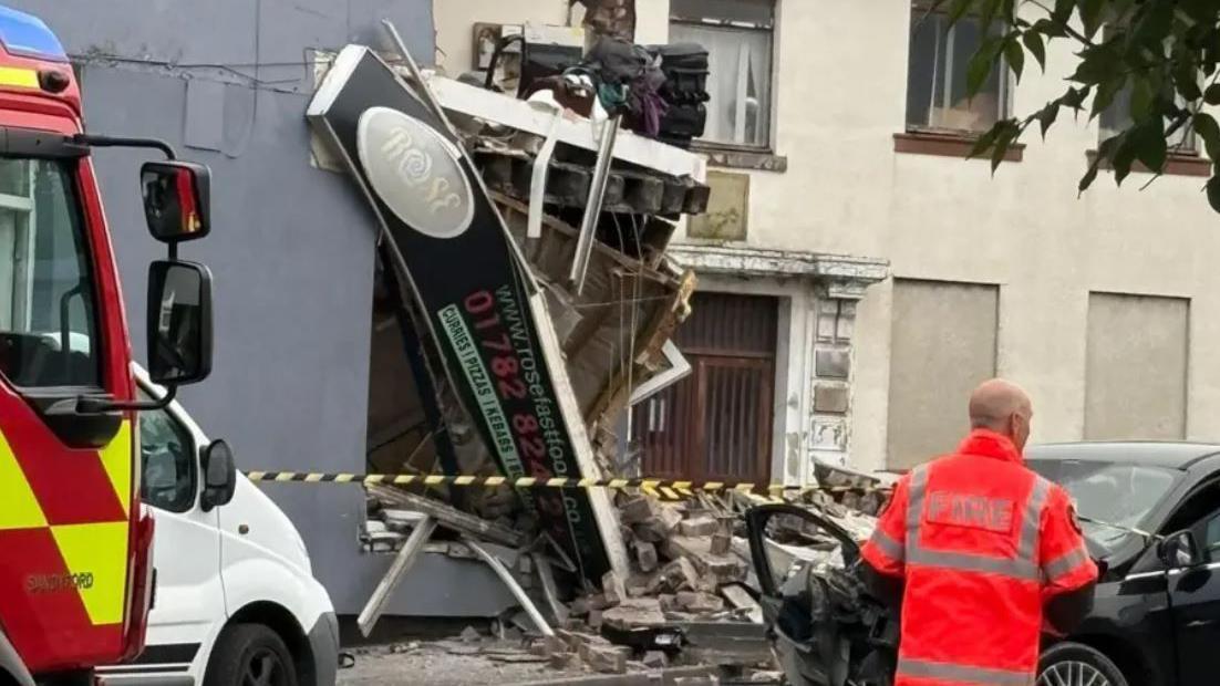 Man charged after car crashes into building