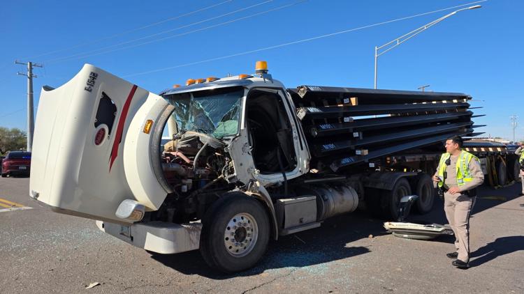 Driver sustains minor injuries after metal beams plow through truck cab ...