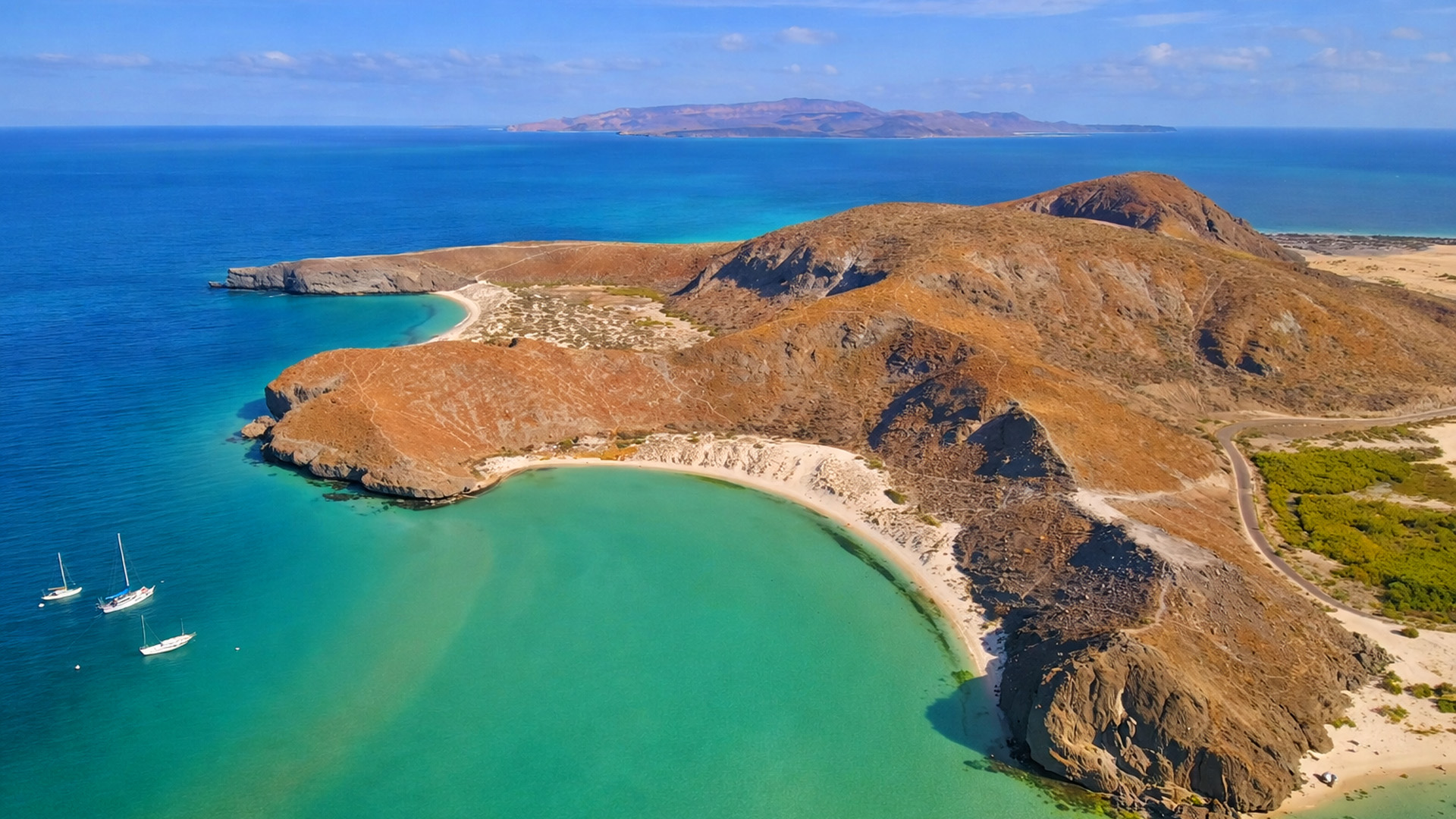 An arid island surrounded by clear blue water