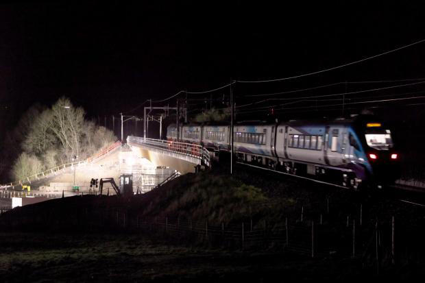 First train passes over new £60 million bridge after 'unprecedented ...