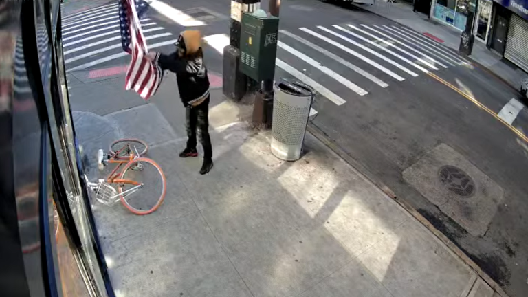 Video shows American flag being slashed "to ribbons" outside Queens bar