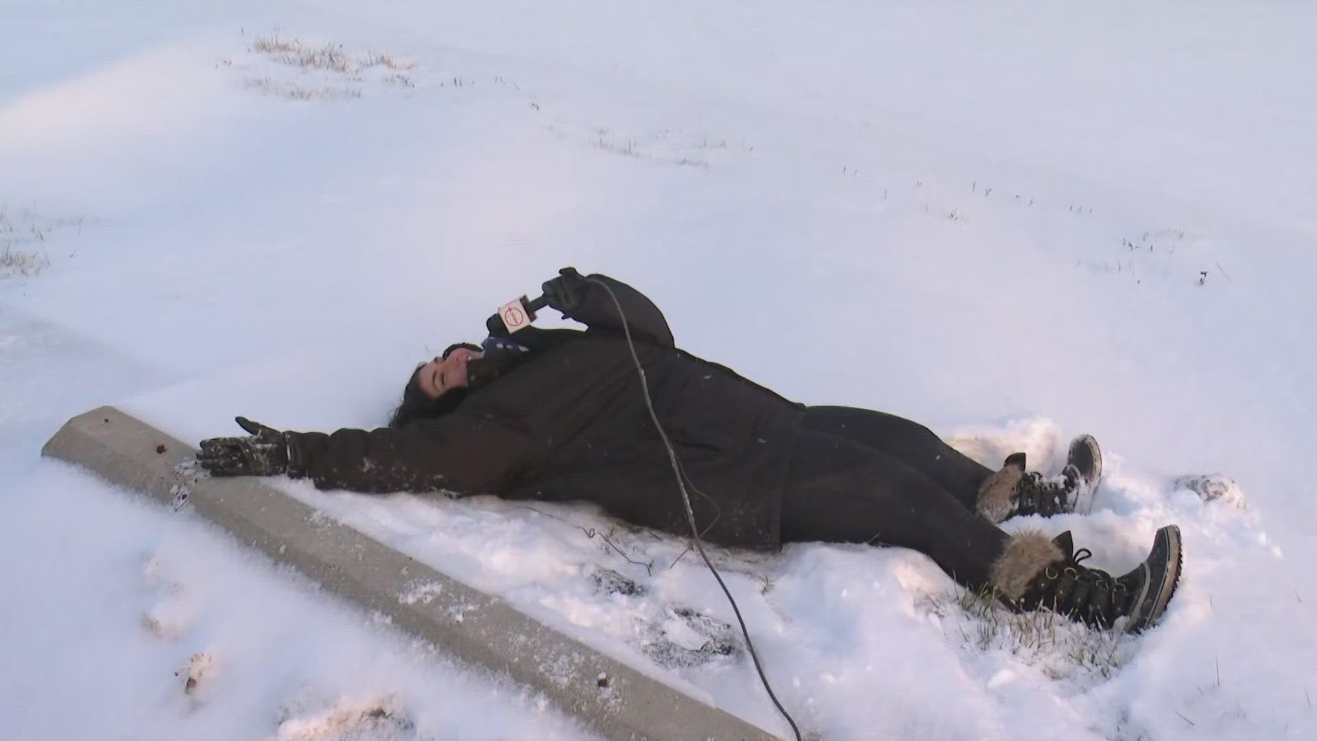 Snow angel, anyone? Kristen Mirand enjoys wintry fun during live report ...