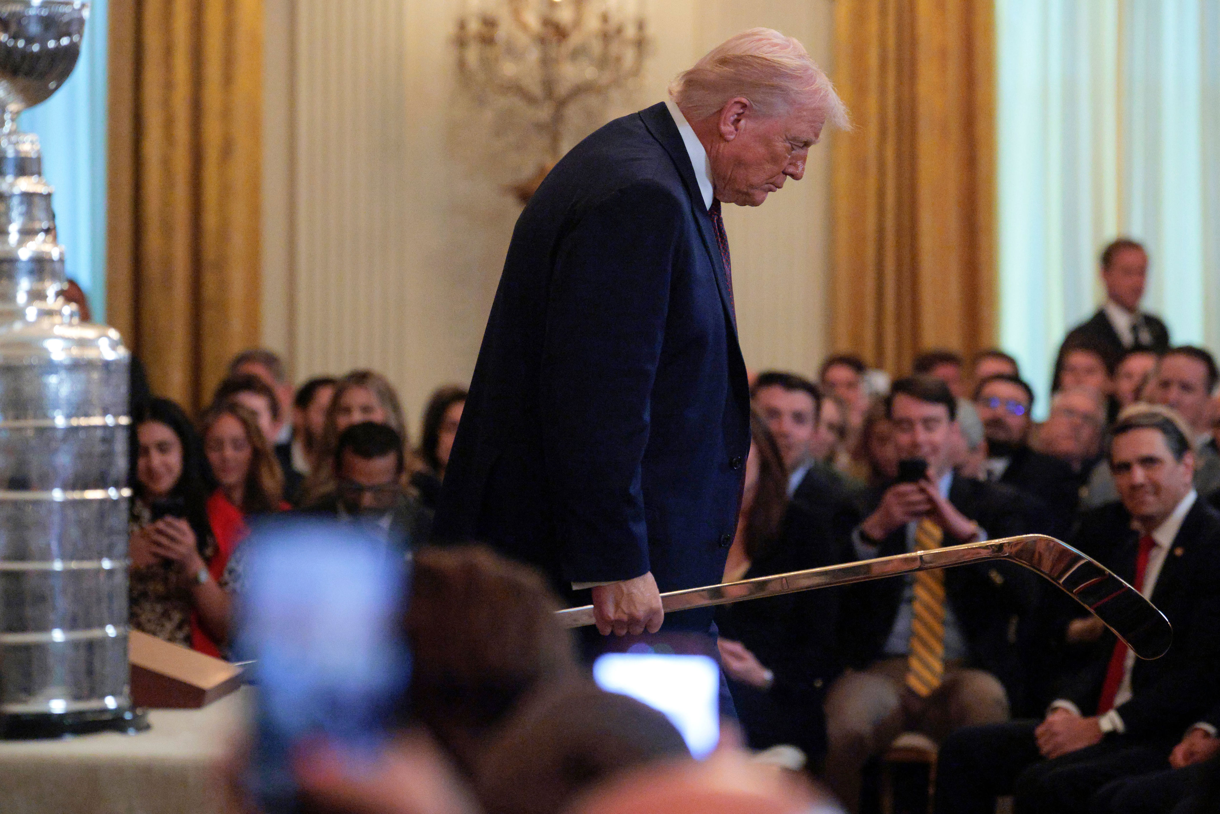 Trump accepts golden hockey stick adding to tacky collection