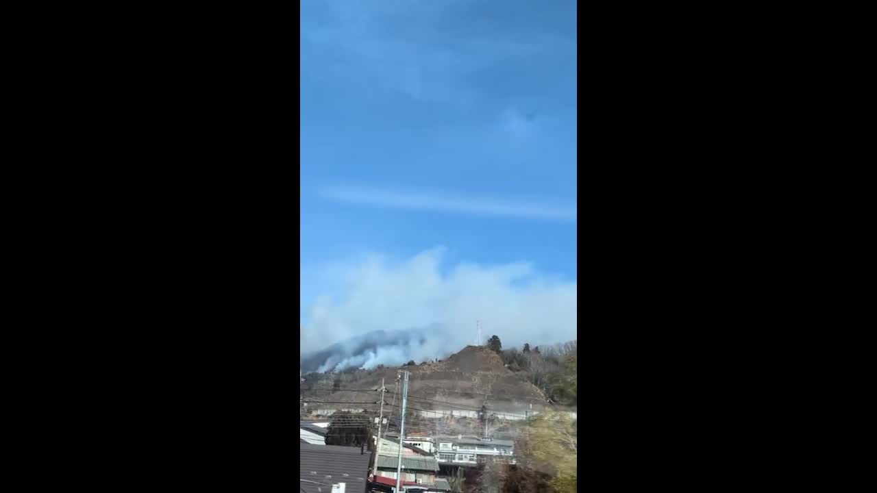 Smoke from mountain fires shrouds homes in Uenohara, Japan