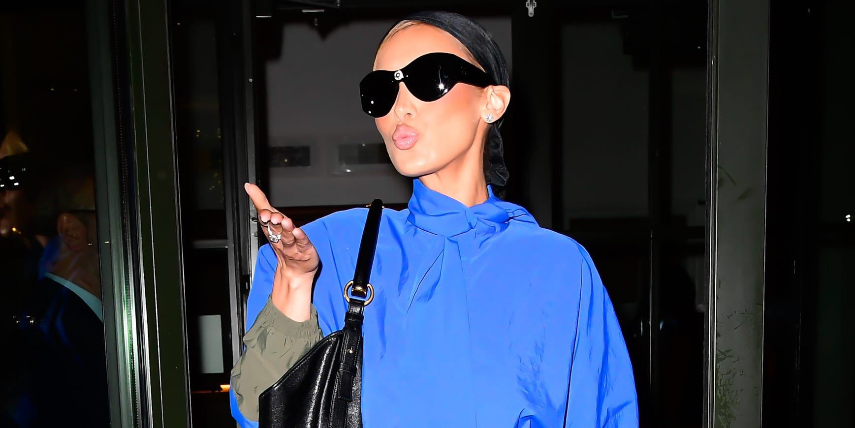 Bella Hadid dresses up a cobalt-blue windbreaker for a night out