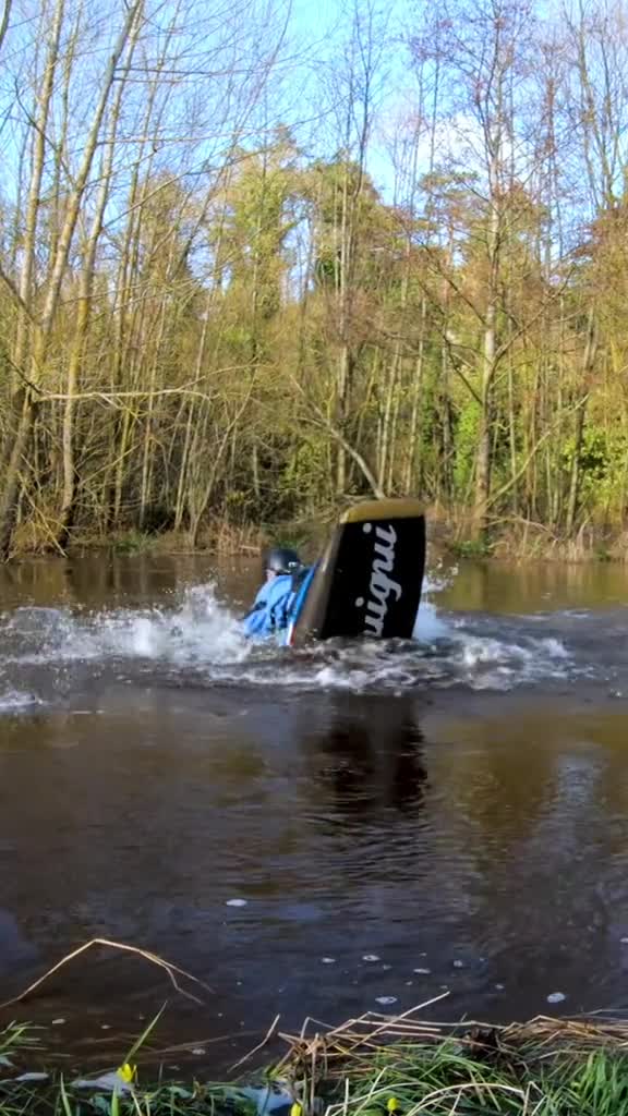 Practicing a flatwater kayak flip on a calm river