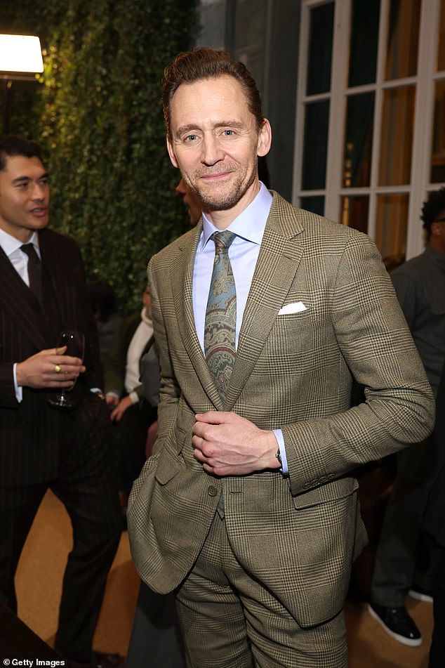 Tom Hiddleston looks dapper as he joins Liam Hemsworth and Nick Jonas ...