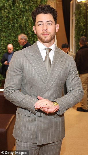 Tom Hiddleston looks dapper as he joins Liam Hemsworth and Nick Jonas ...