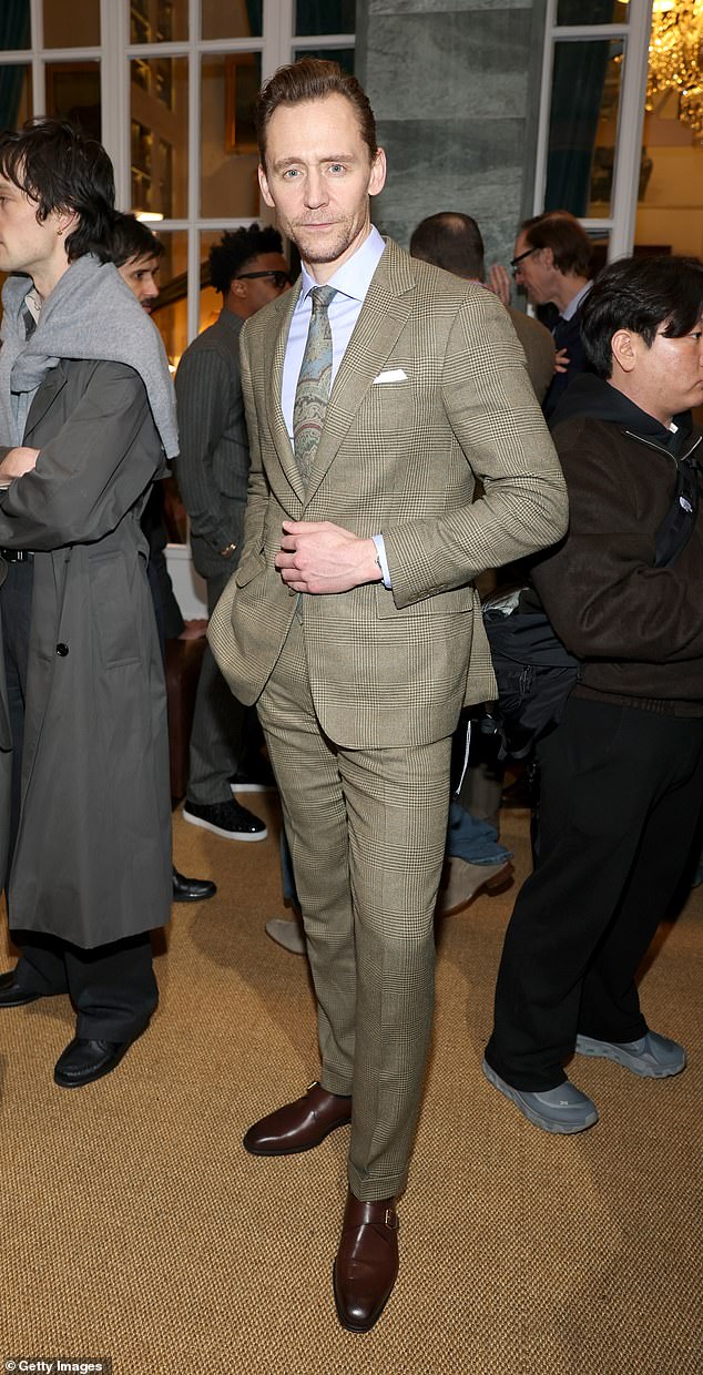 Tom Hiddleston looks dapper as he joins Liam Hemsworth and Nick Jonas ...