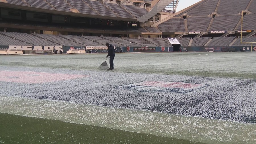 How do crews keep the snow and ice off the turf at Soldier Field?