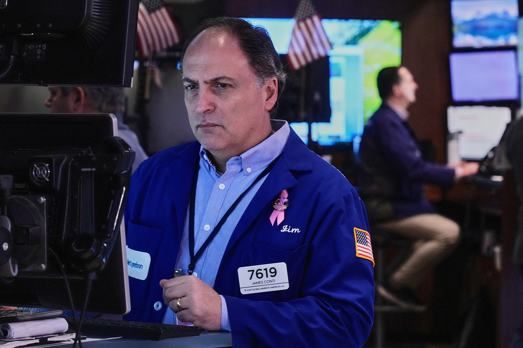 Stocks edge a bit below their latest records on Wall Street