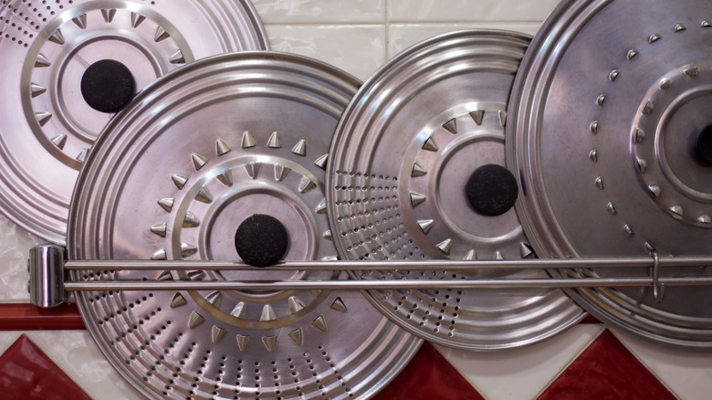 Repurpose old pot lids into charming kitchen decor that doubles as storage