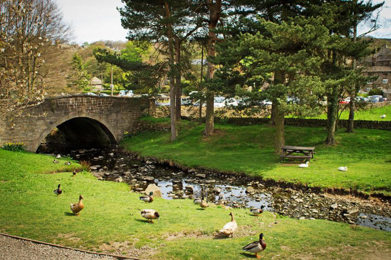 Idyllic Yorkshire village with babbling brook, ancient bridges is ...