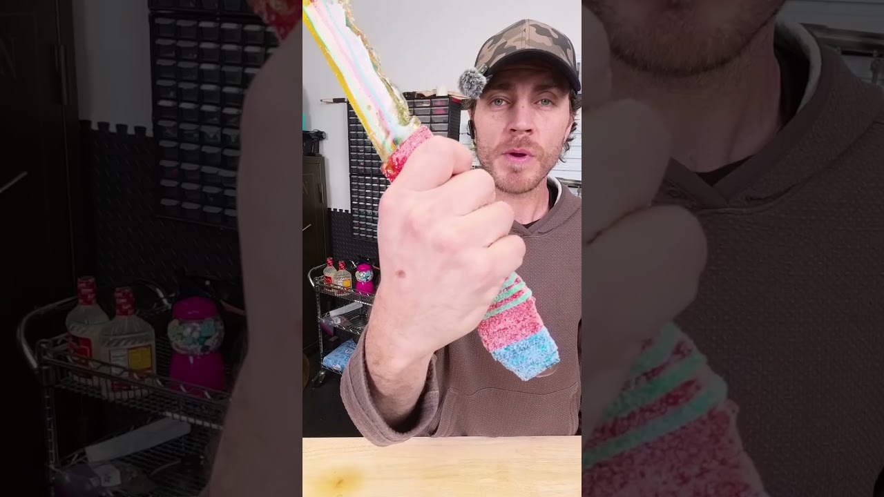 Carving a pumpkin with a giant candy sword shown