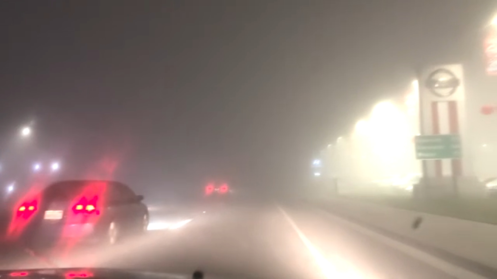 Dense fog blankets the valley, creating dangerous driving conditions