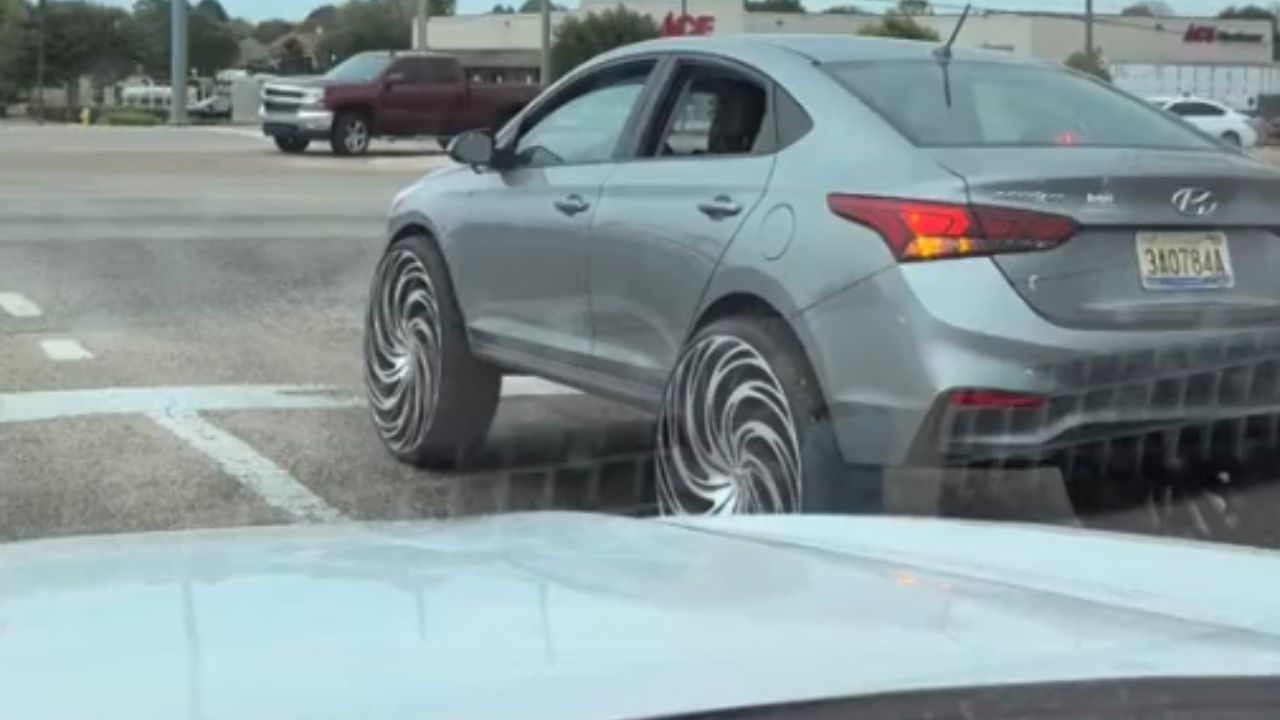 Unconventional rims on a car create a humorous and eye-catching moment ...