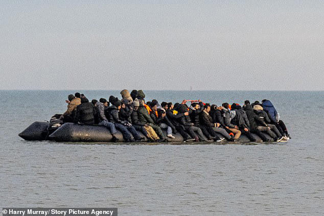 Migrants brave icy cold sea to pile onto overloaded dinghy for latest ...