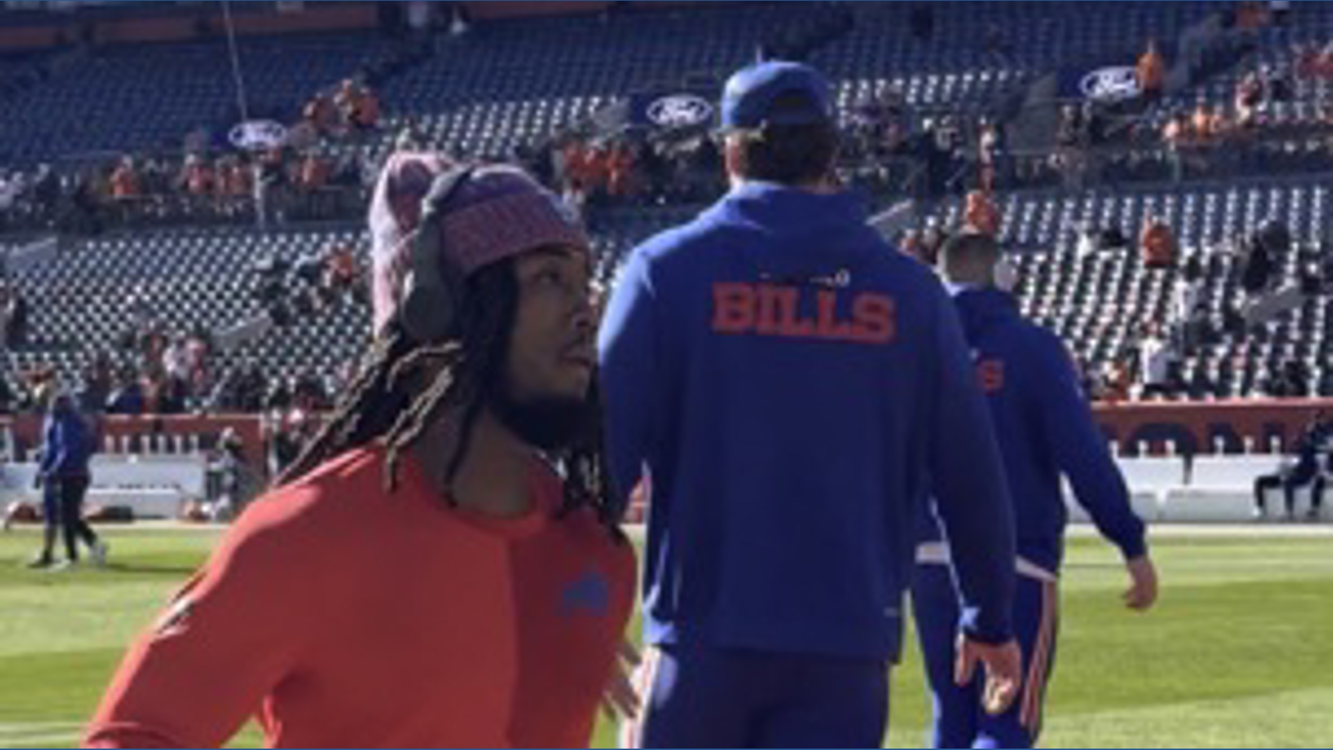 James Cook jogs around Empower Field during pregame warmups